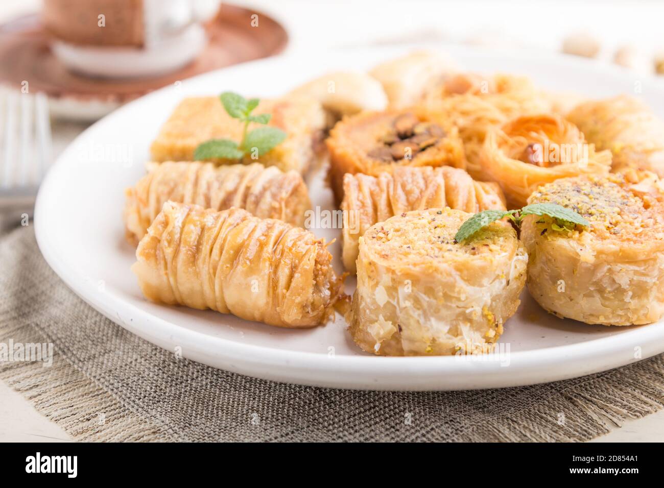 traditional arabic sweets (kunafa, baklava) and a cup of coffee on a ...
