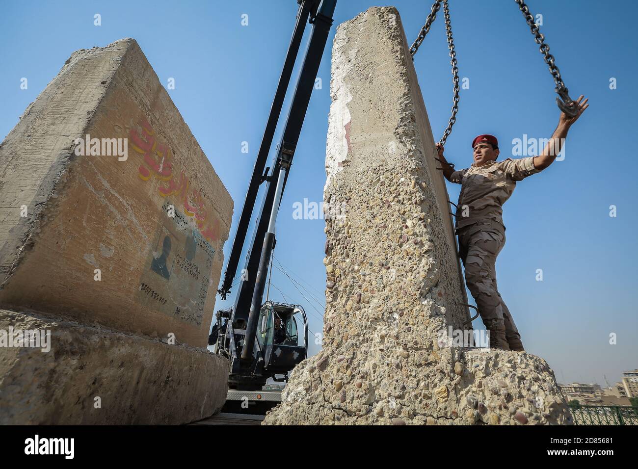 Baghdad, Iraq. 27th Oct, 2020. An Iraqi soldier attaches the hook of a ...