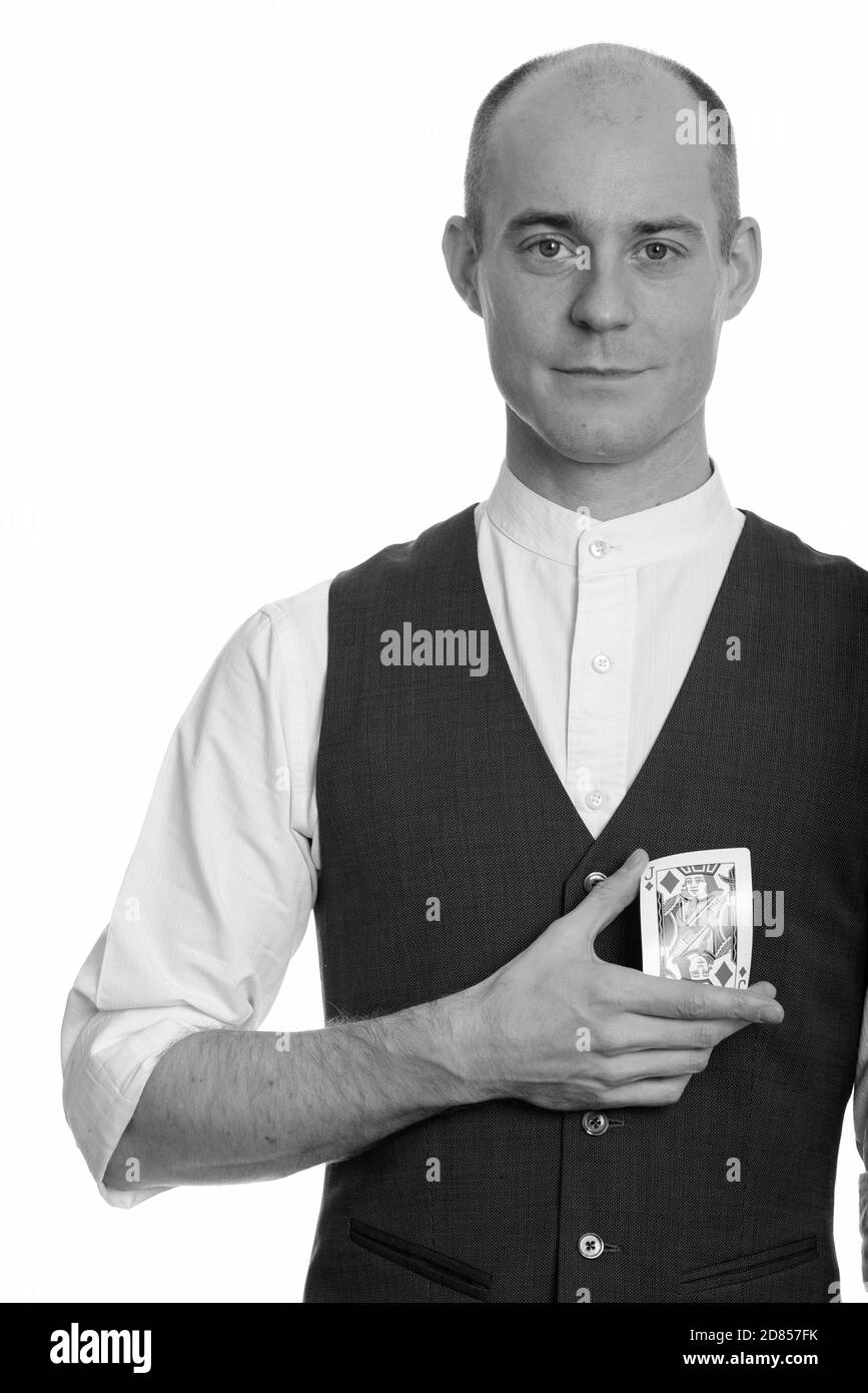 Bald Caucasian magician man bending Jack of Diamonds card Stock Photo ...
