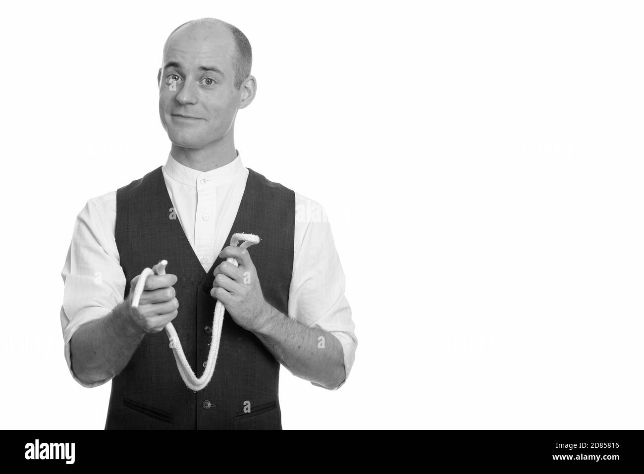 Bald Caucasian magician man holding rope for magic trick Stock Photo ...