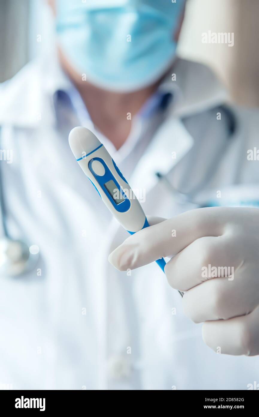 doctor gives a thermometer to measure the patient's temperature ...