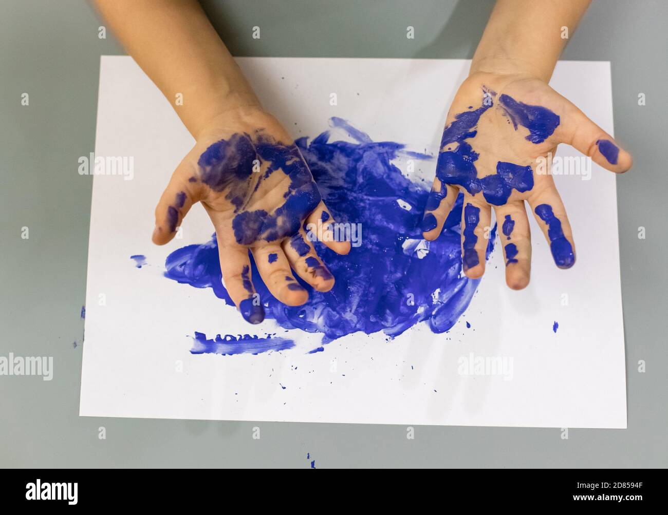 child's hands in blue paint. early development concept. art, creative ...