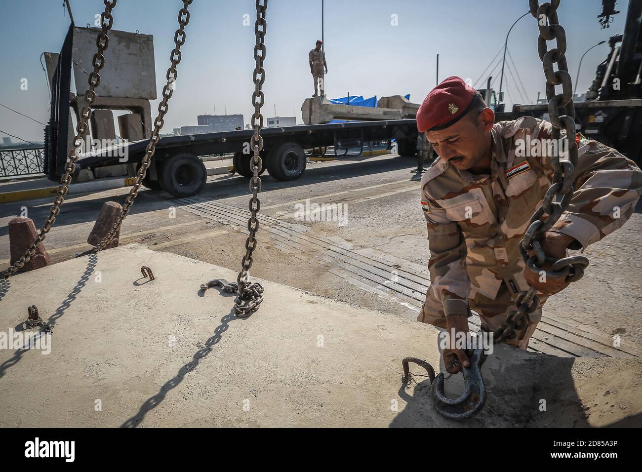 Baghdad, Iraq. 27th Oct, 2020. An Iraqi soldier attaches the hook of a ...