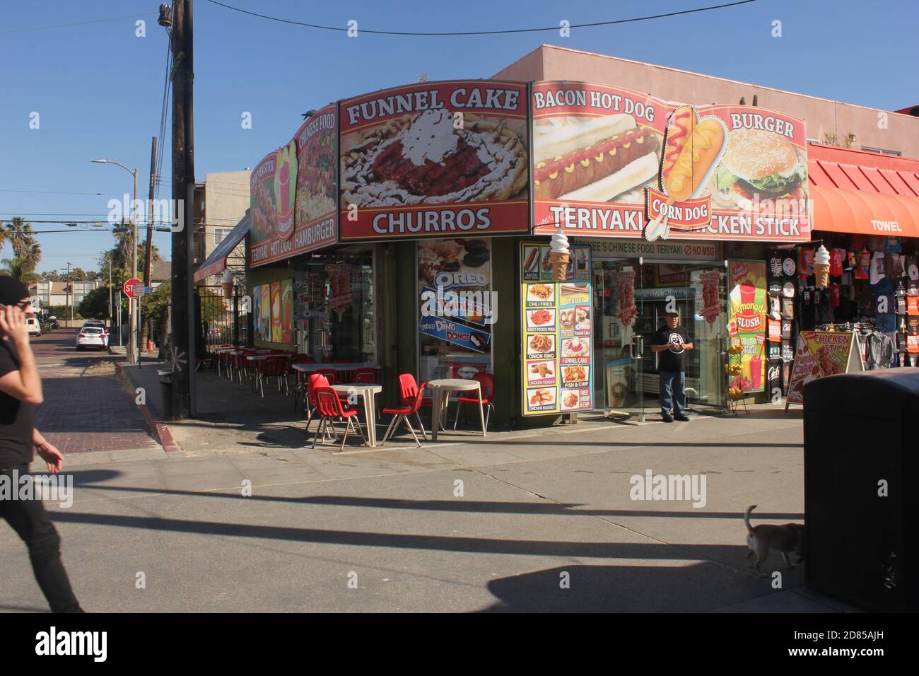 Several colorful snack shacks in a row offering different kinds of food ...