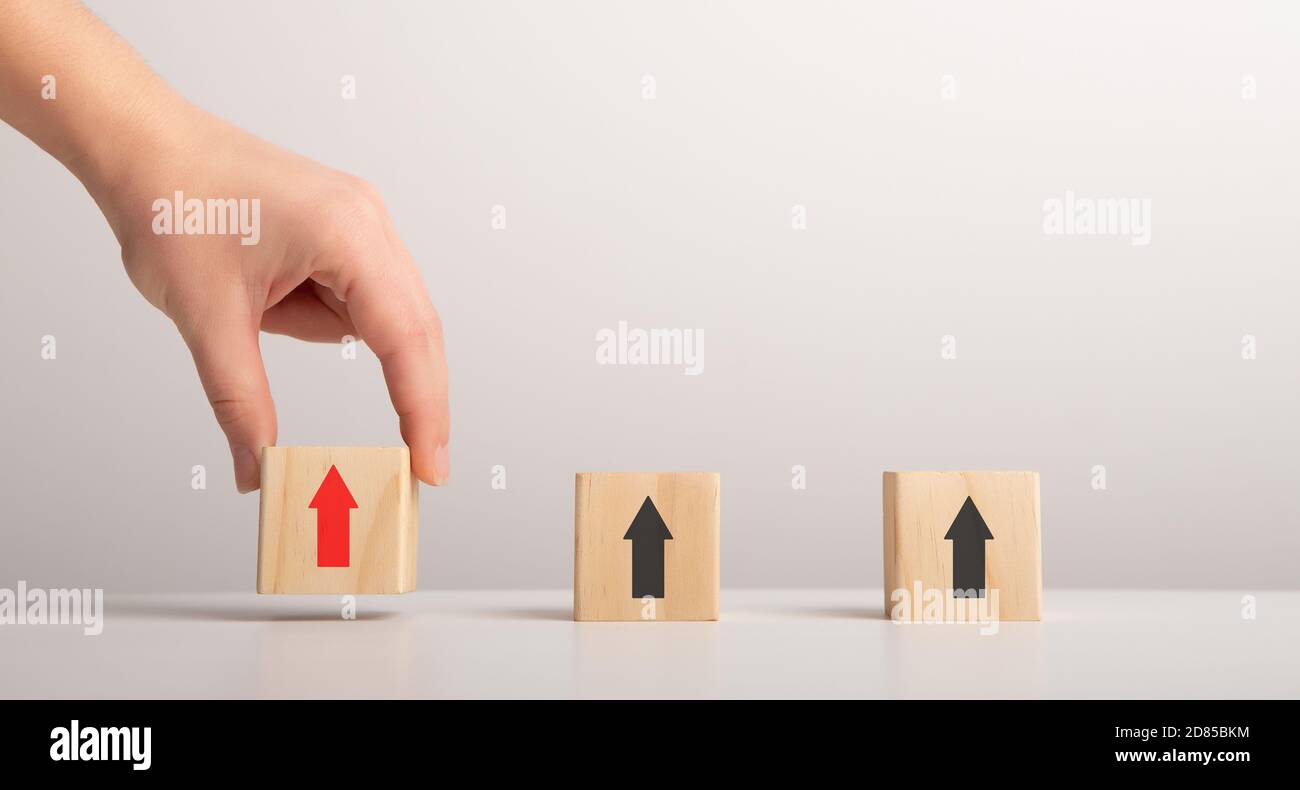 Female Hand Putting Wooden Blocks With Arrows Up, Gray Background Stock ...