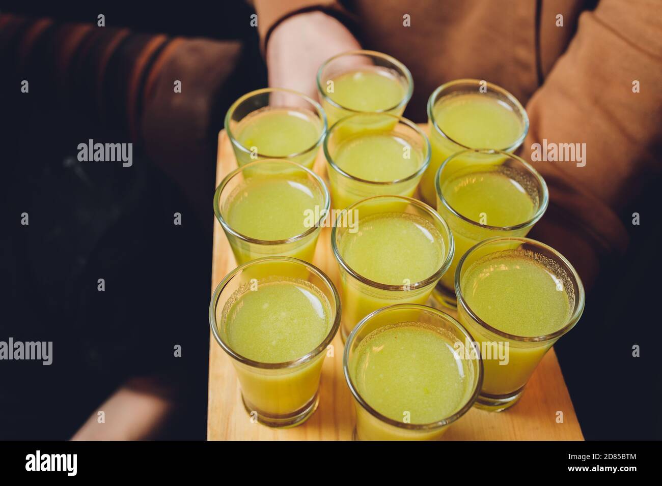 Various alcoholic shots in shot glasses in a serving tray often used ...