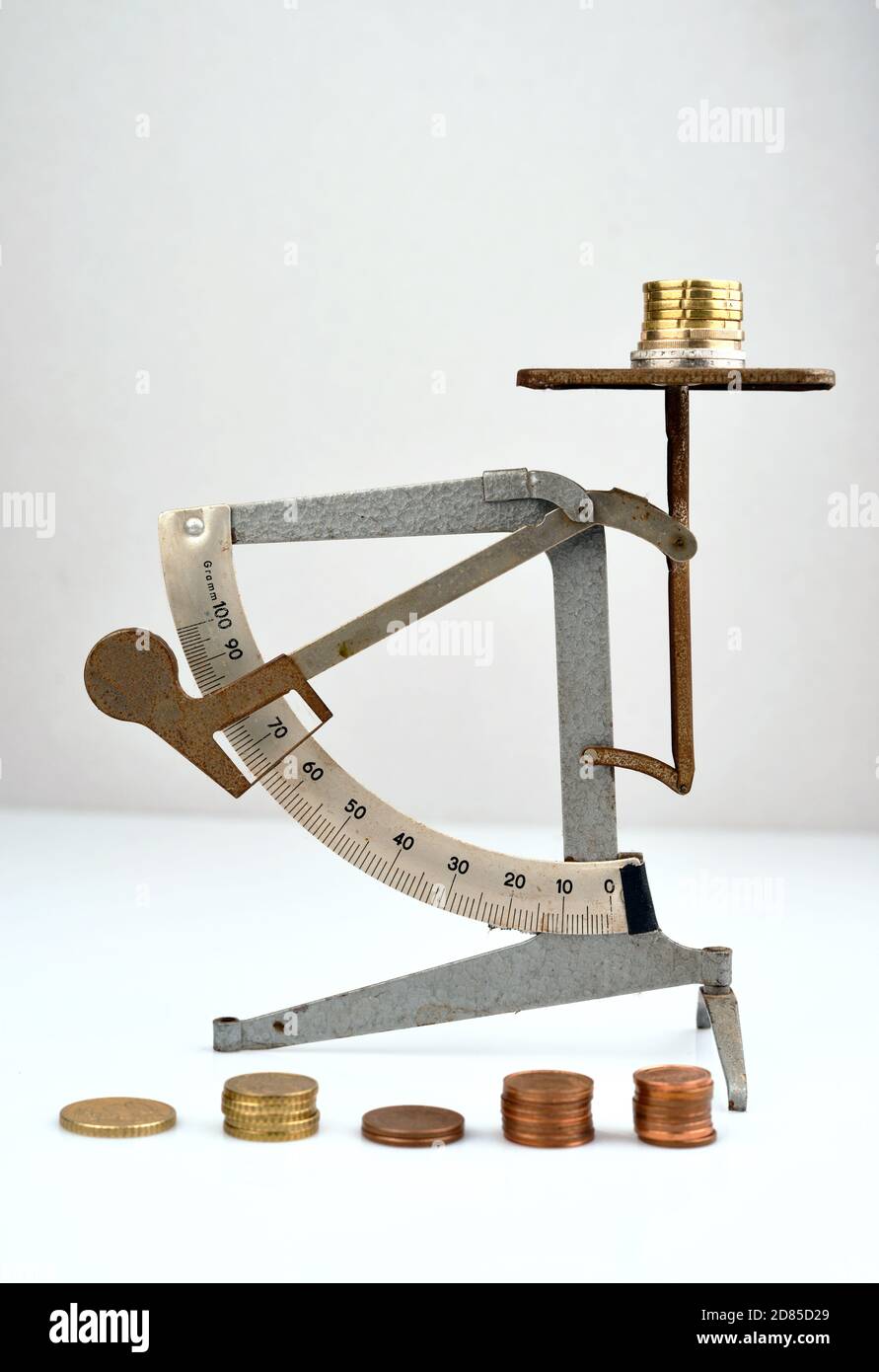 Euro coins on a scale isolated money concept Stock Photo - Alamy