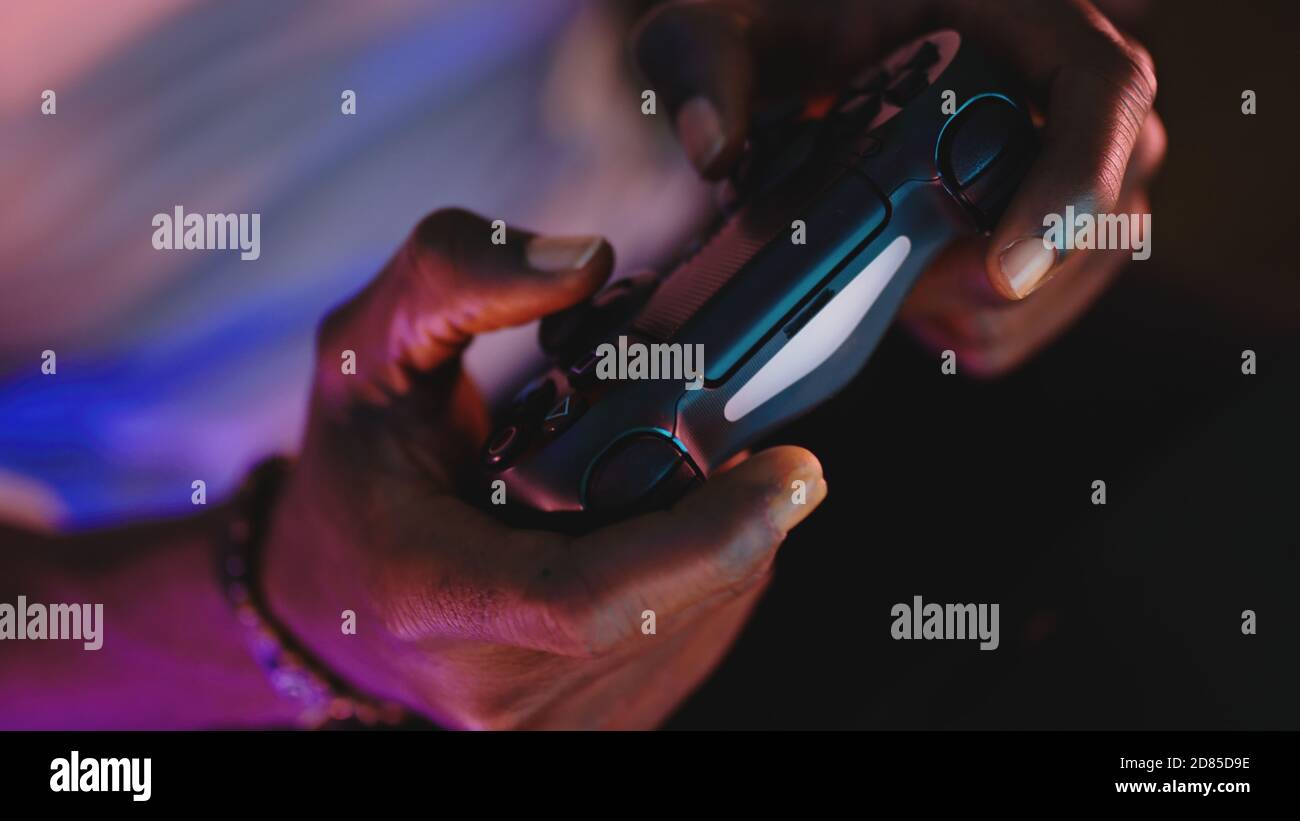Close up, hands of black man holding video game joystick. High quality ...