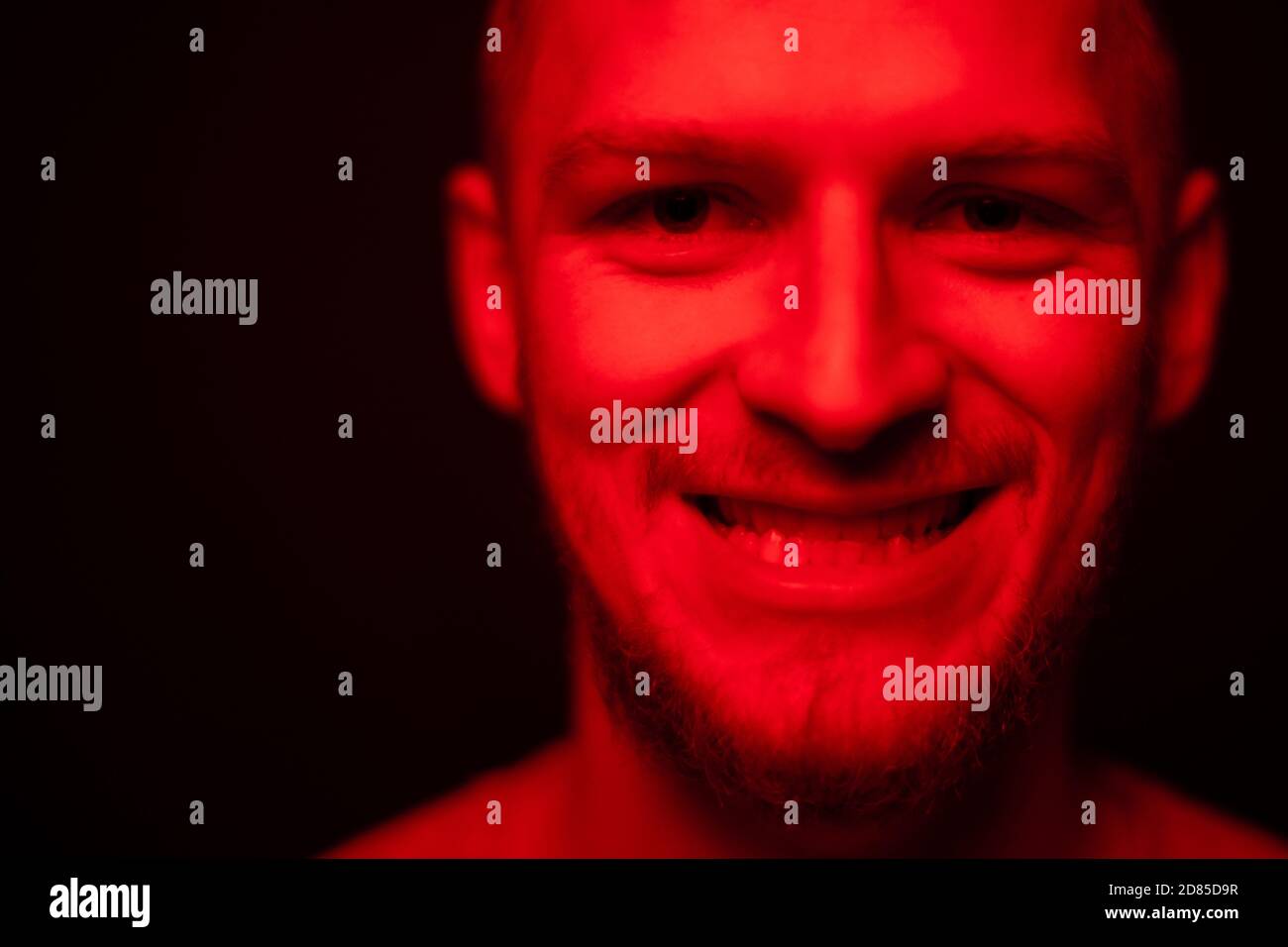 Low key portrait of bearded young man Devilish facial expression, devil ...