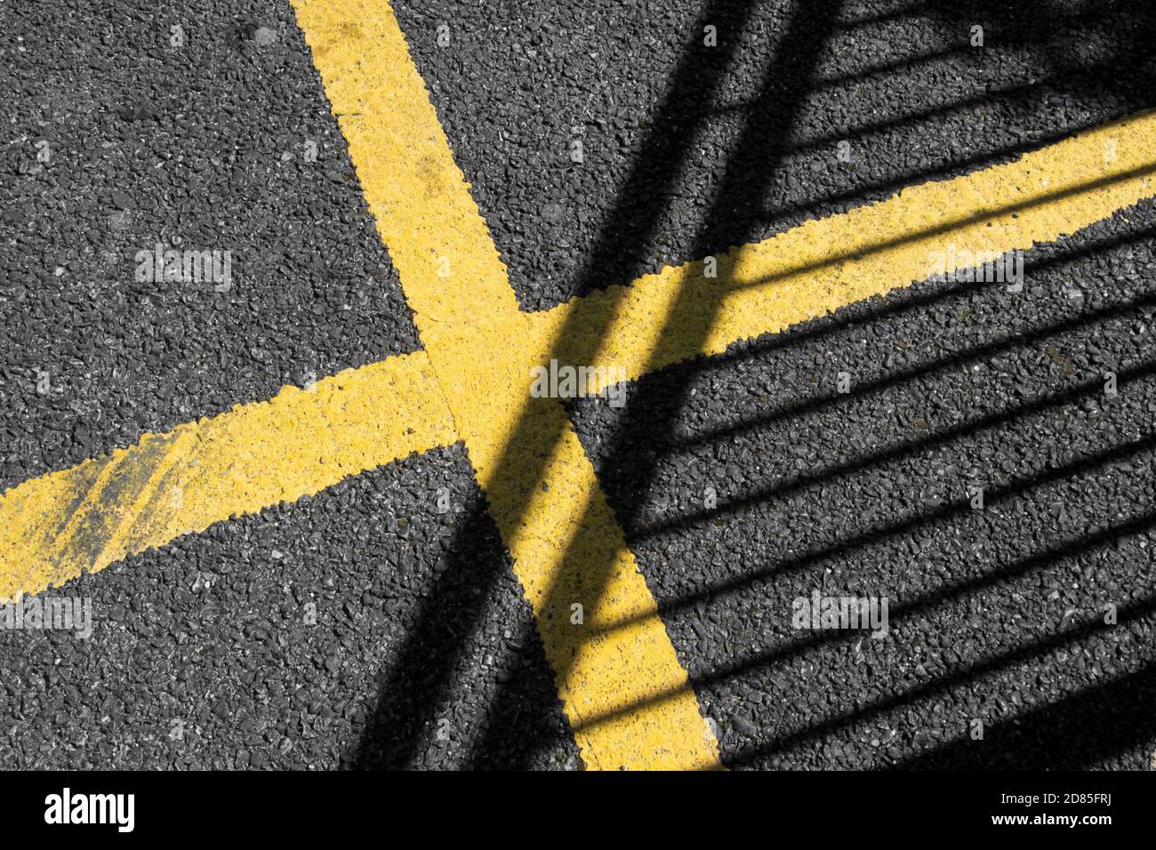 road pavement yellow line marking with gate shadow Stock Photo - Alamy