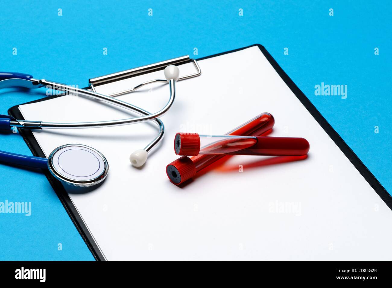Healthcare concept - stethoscope, blood test tube and clipboard with ...