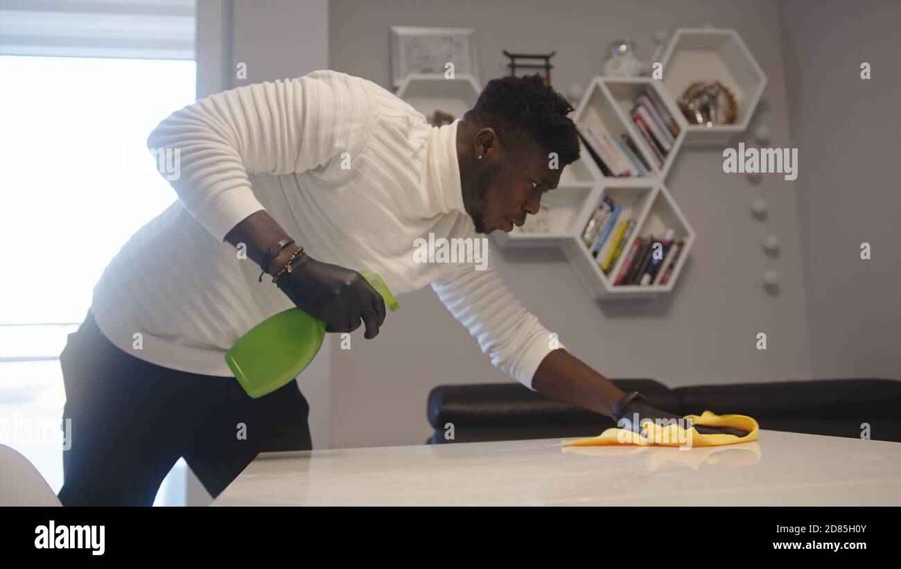 Young happy african american black man wiping the dining table. High quality photo Stock Photo ...