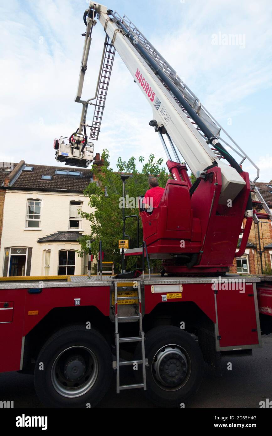 A fire engine appliance fitted with a long arm crane attends an ...