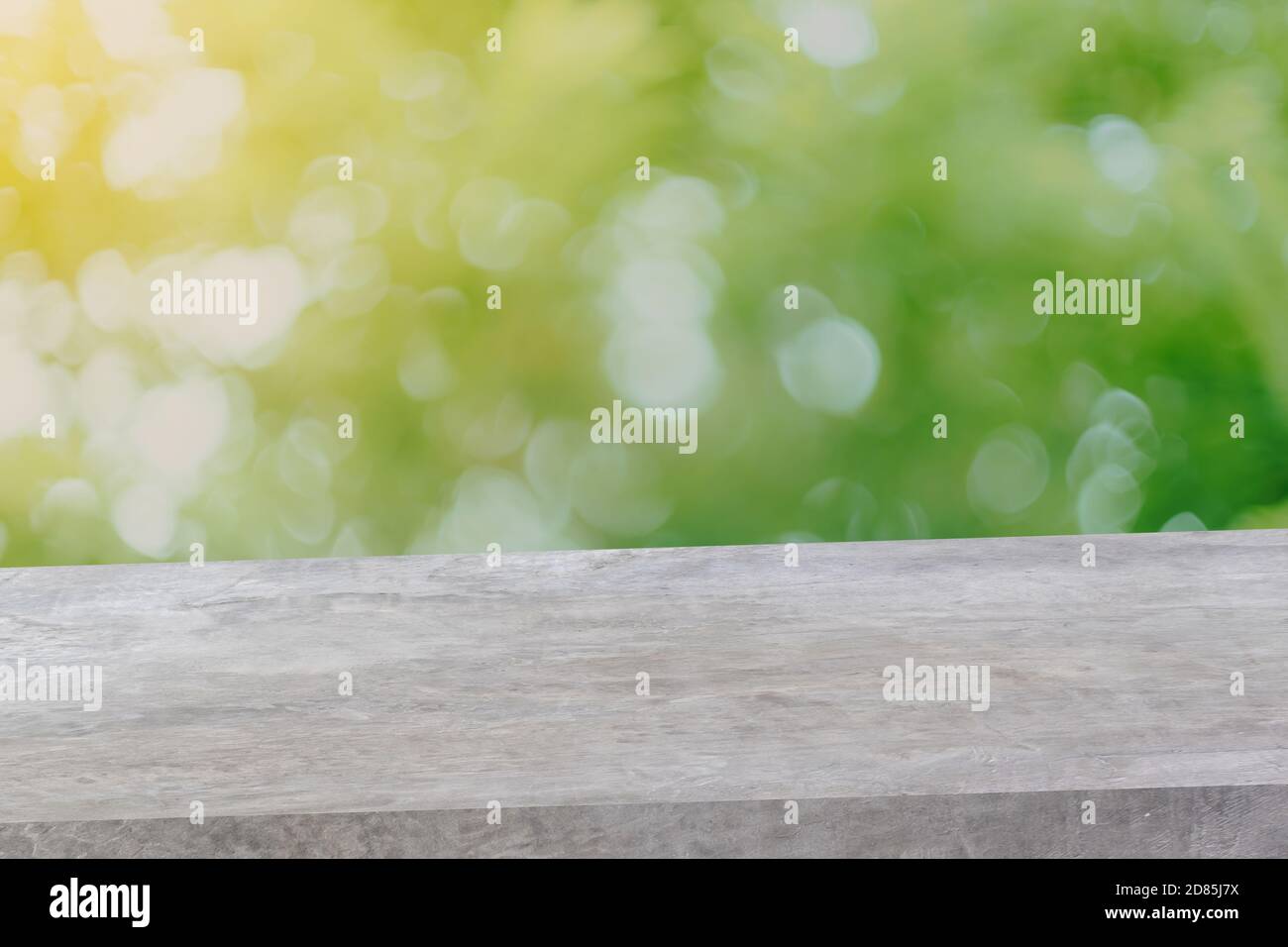 Empty diagonal concrete table with blur tree in garden boekh and mock ...