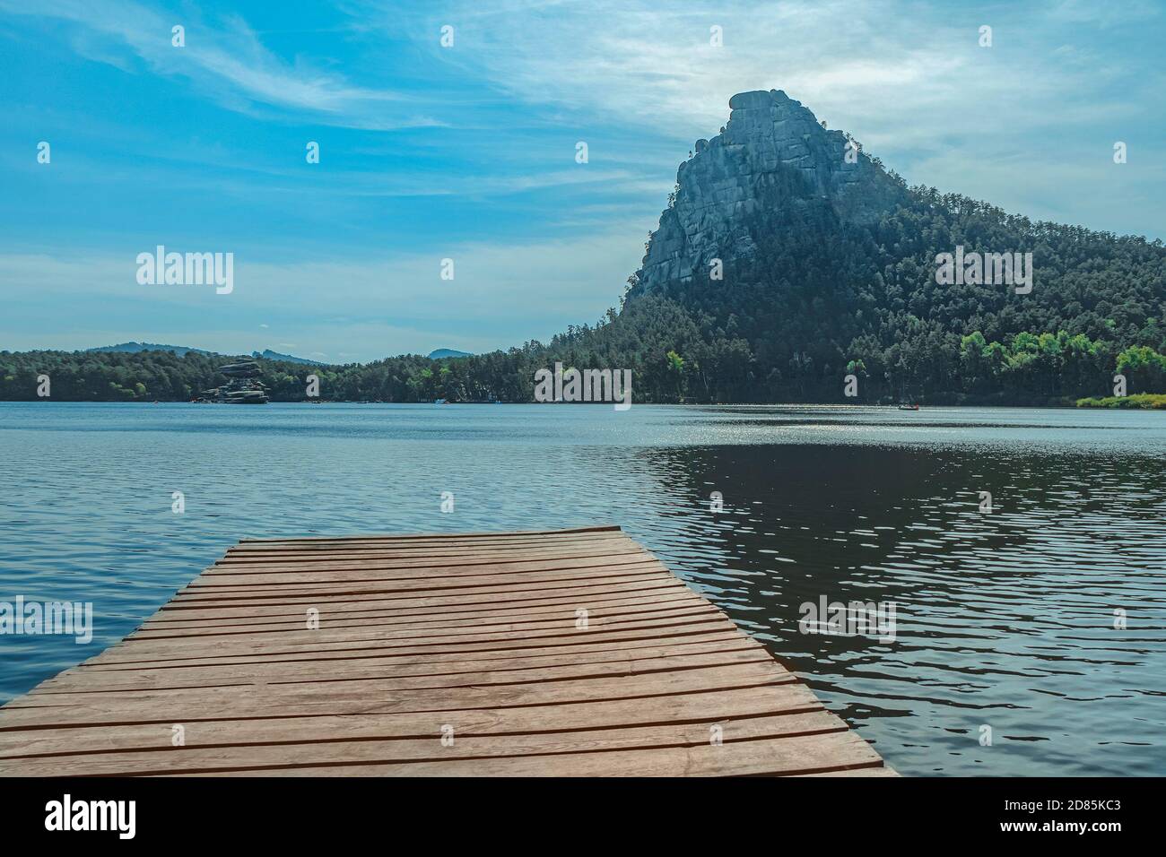 Pier against the backdrop of mountains and forest. Forest scene and ...