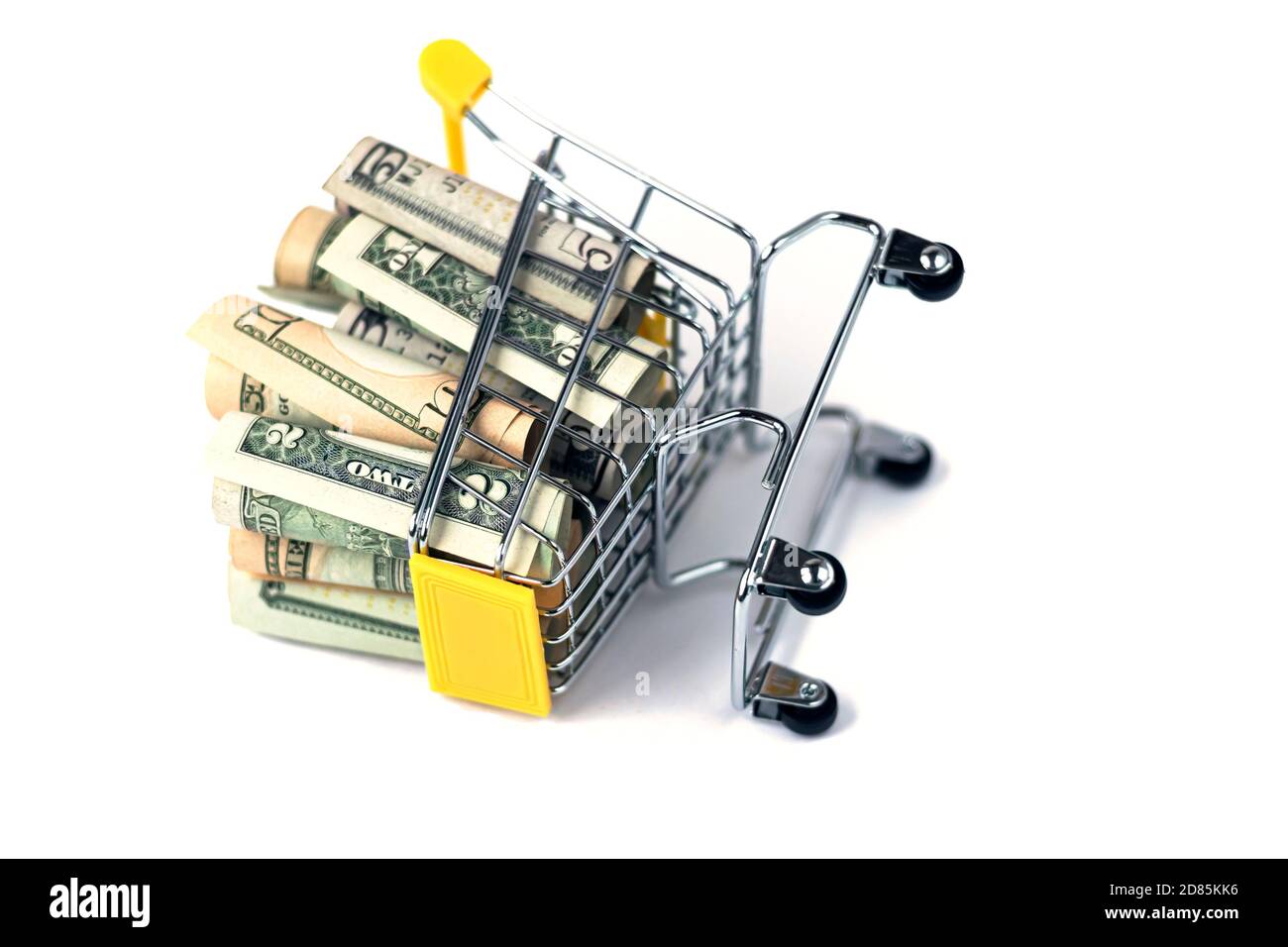 small shopping trolley, filled with cash dollars. Dollars in yellow ...