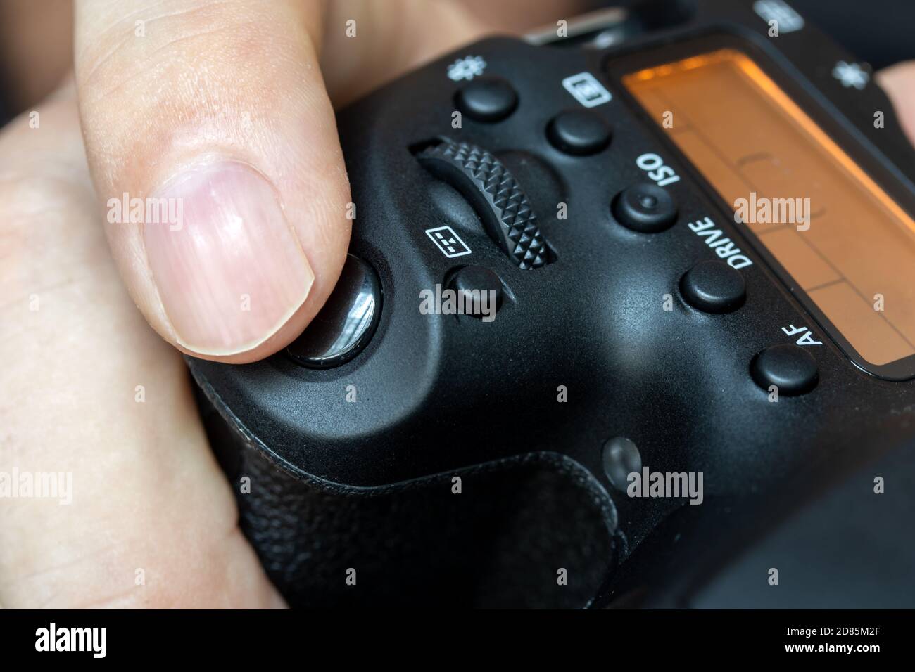 A pressing the shot button of a digital photo camera, close up. A take ...