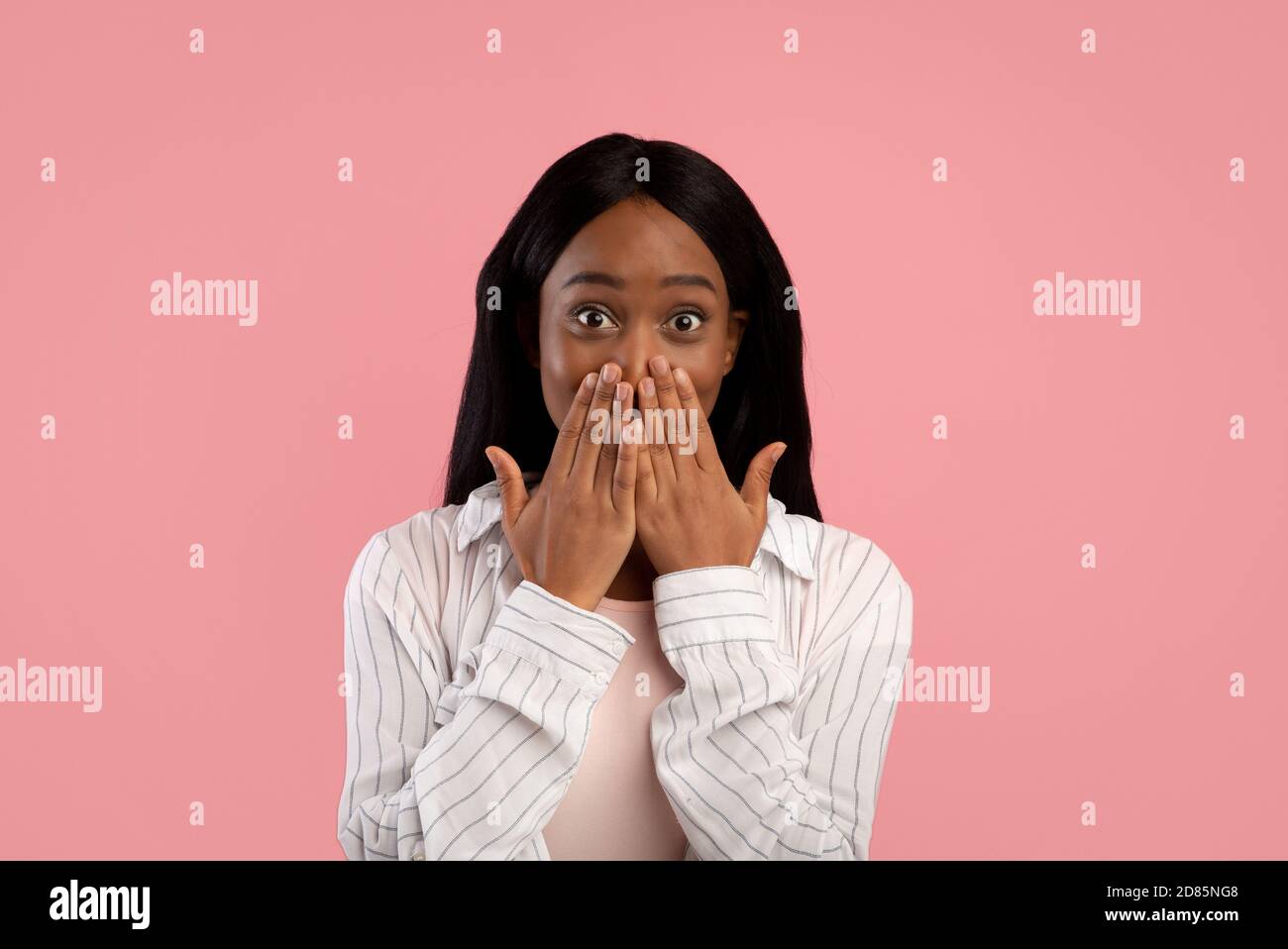 Shocked African American Woman Covering Her Mouth With Hands In