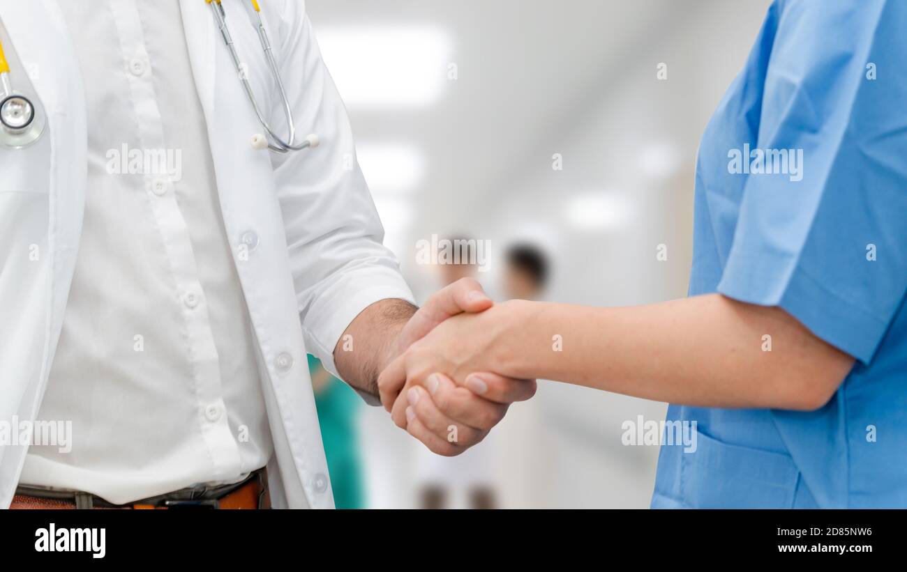 Doctor in hospital handshake with another doctor. Healthcare people ...