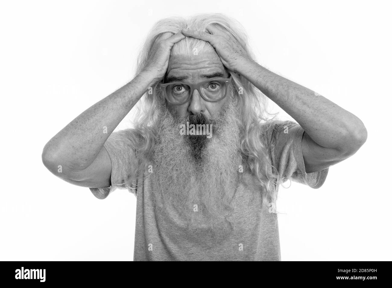 Close up of senior bearded man thinking while looking shocked with both ...