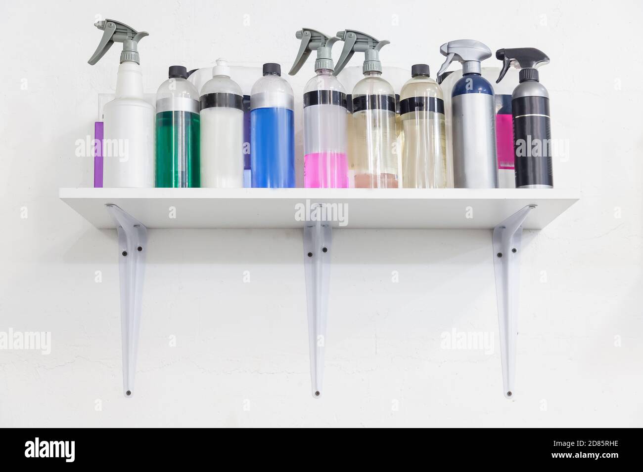 Shelf on a white wall in a workshop with a working tool - containers ...