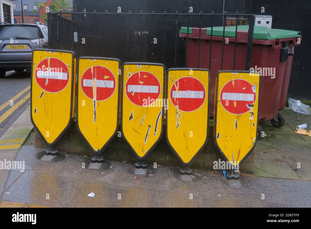 Five no entry signs in street stood by wheelie bin Stock Photo - Alamy