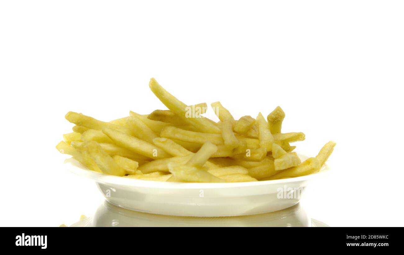 French fries on plastic disposable plate rotating on white background ...