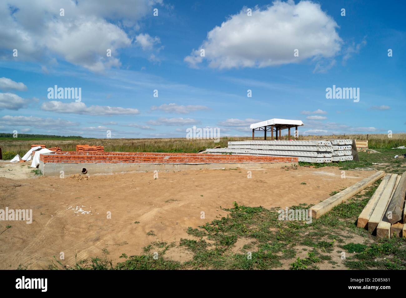 The Construction of the foundation for building in field on background ...