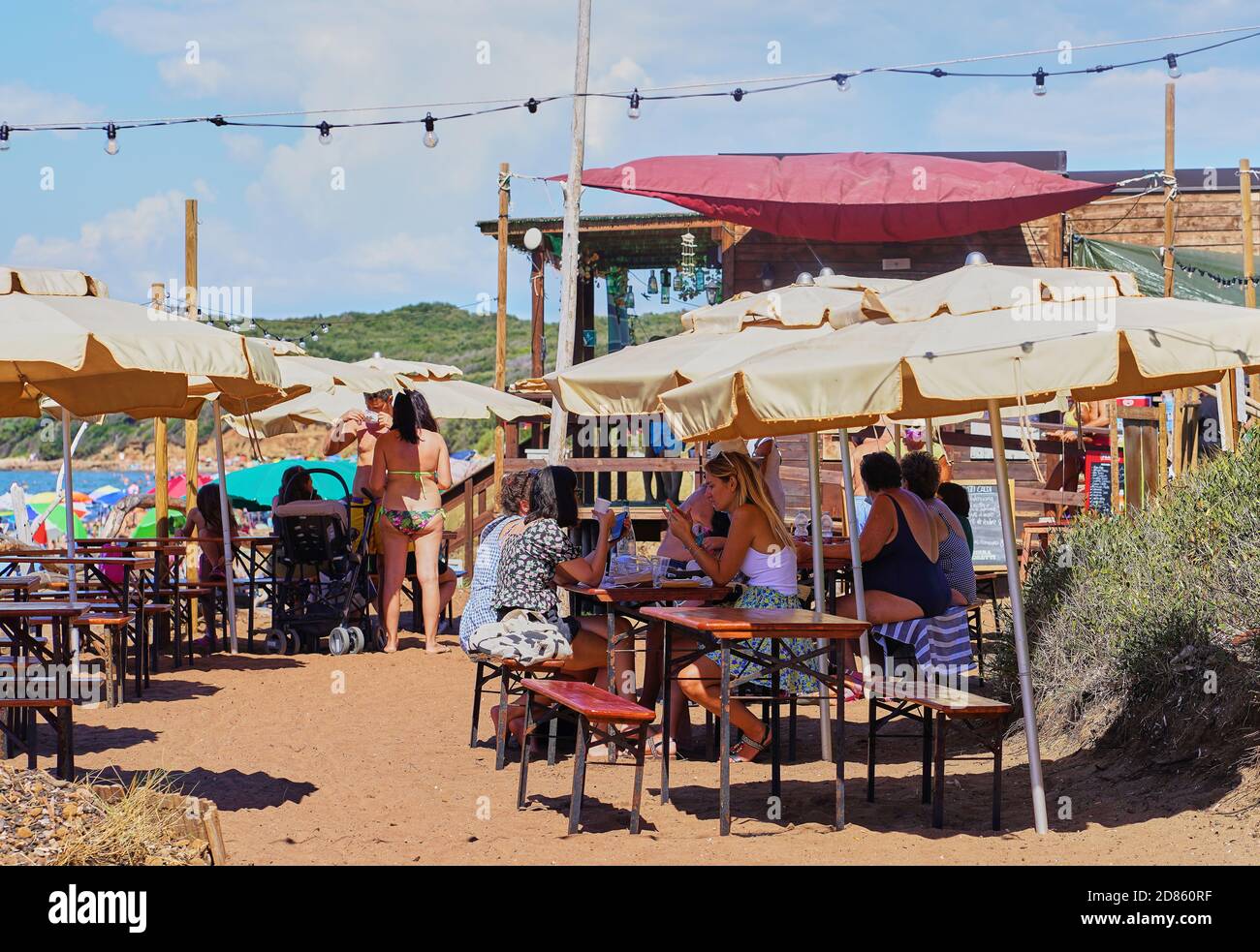 Tourists and local people enjoy the restaurants and bars at Baratti ...