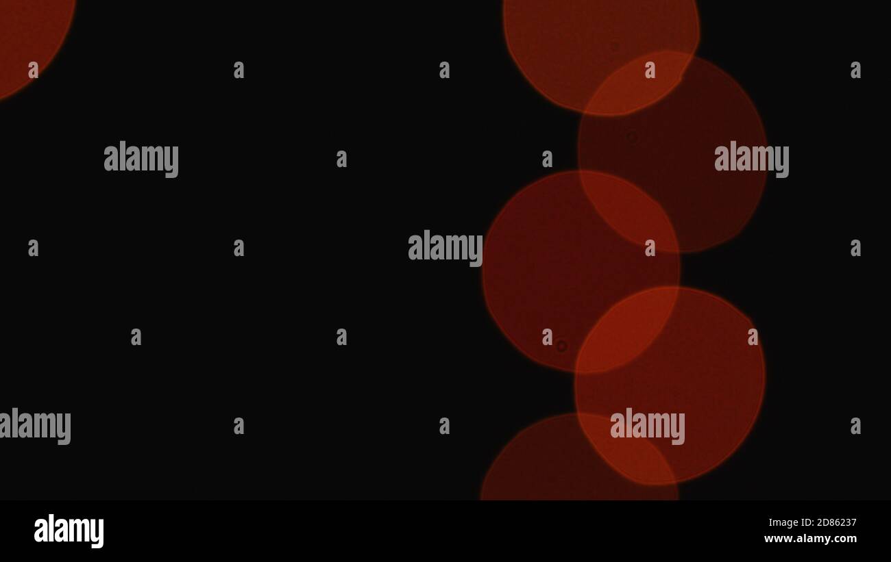 deep blurred dull Christmas lights light up slowly and fade out on dark ...