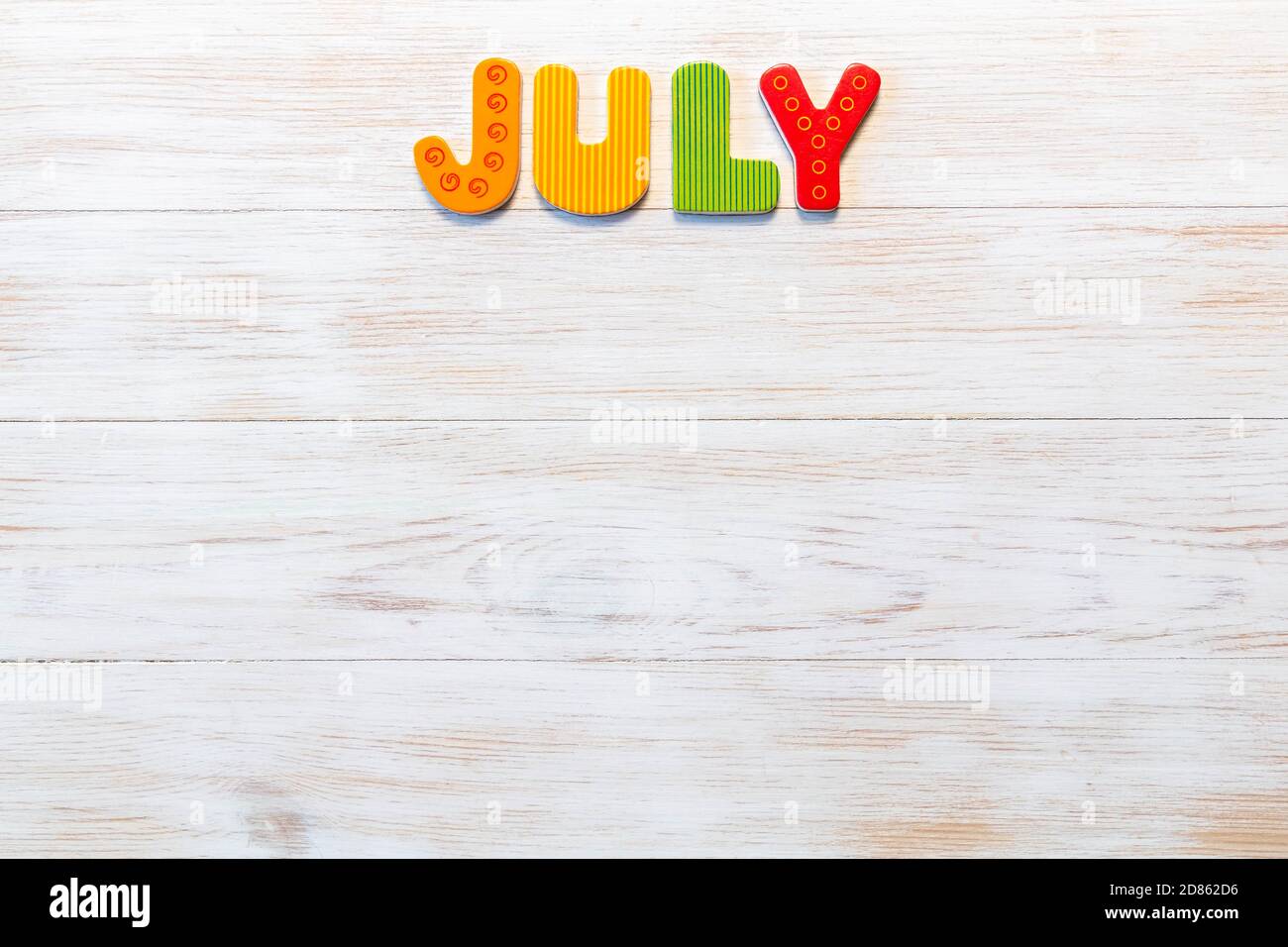 Wooden letters written July month on vintage background. Inscription ...