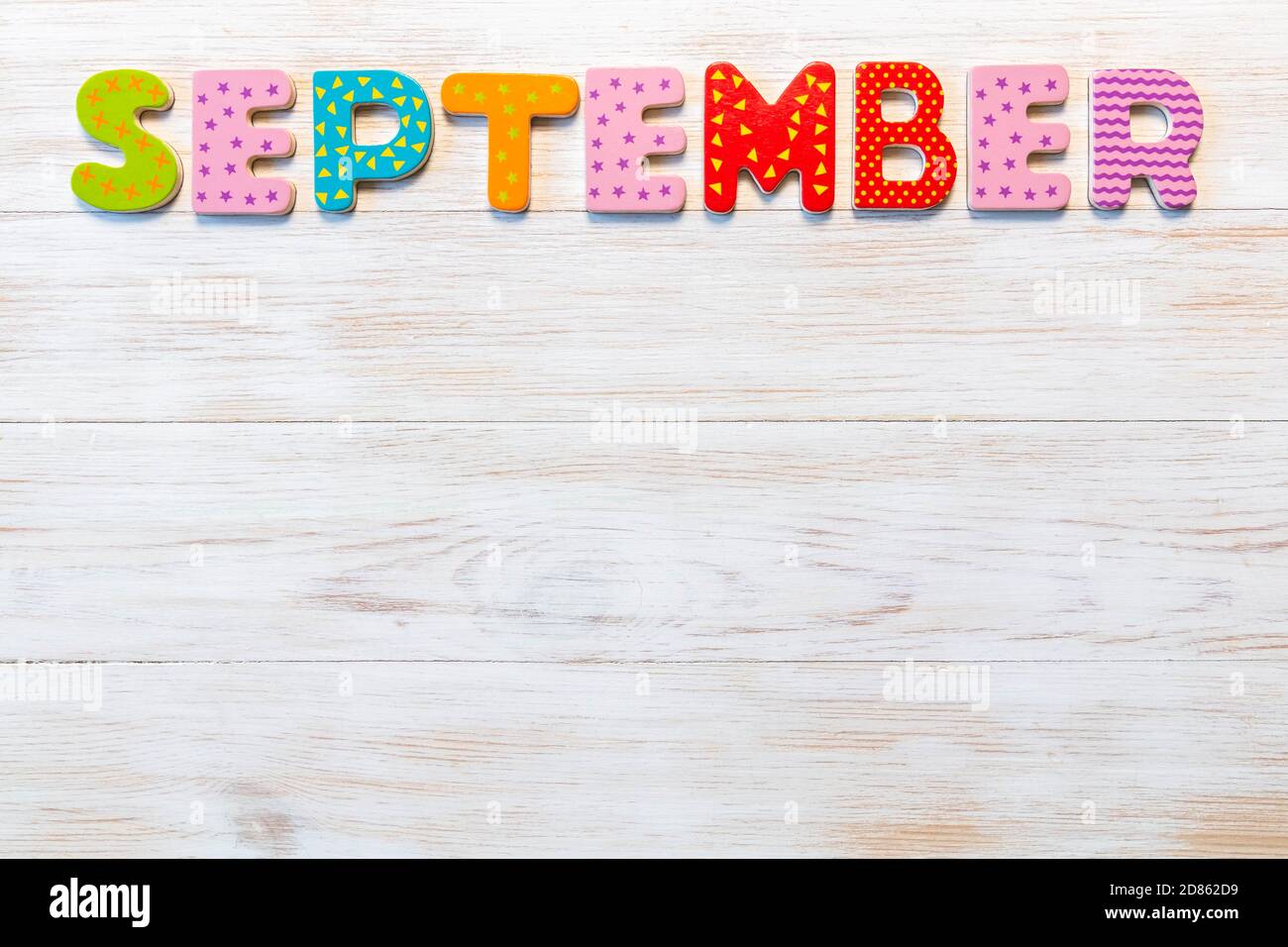 Wooden letters written September month on vintage background ...