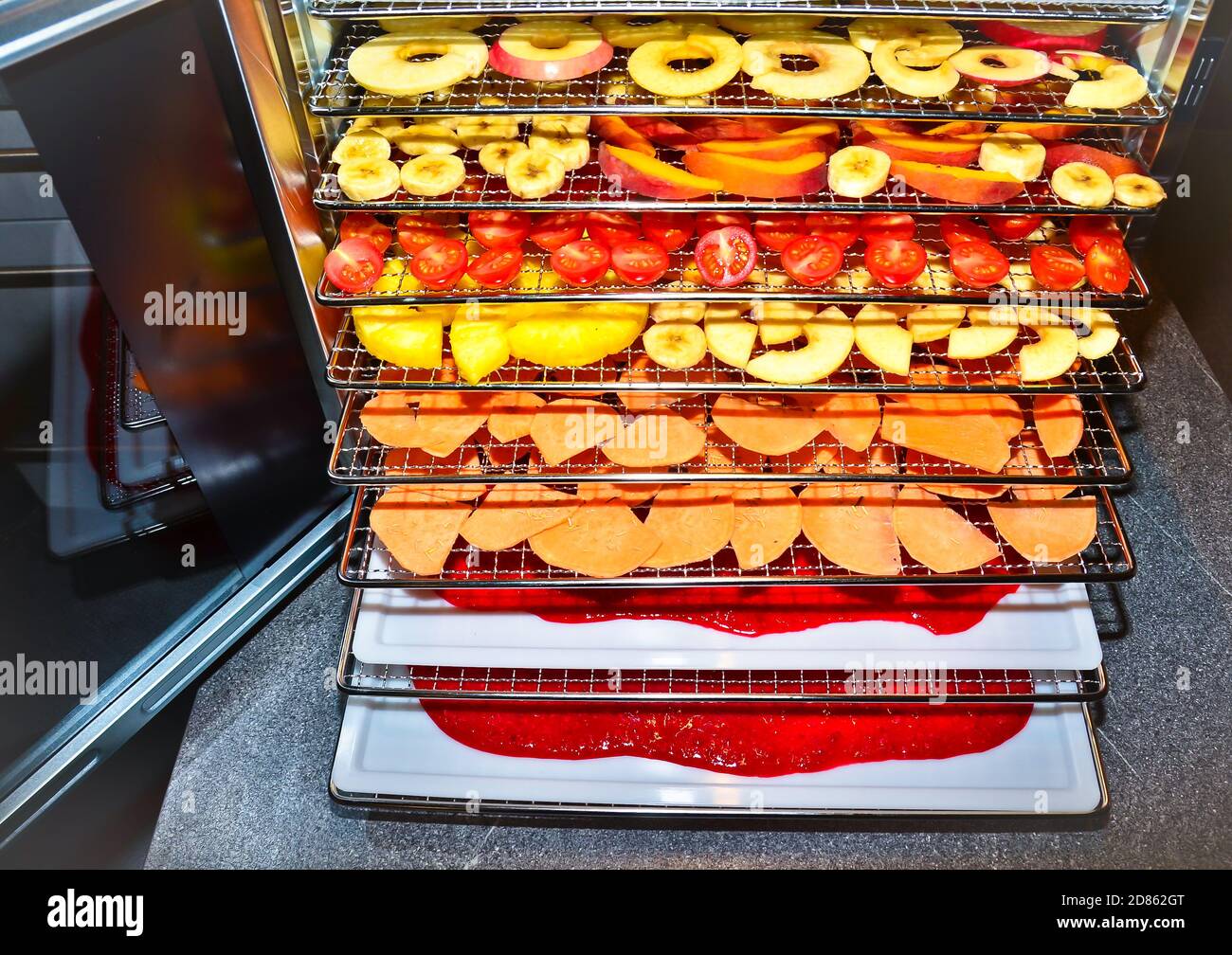 a plate dryer, a drying kiln filled with several different fruits and ...