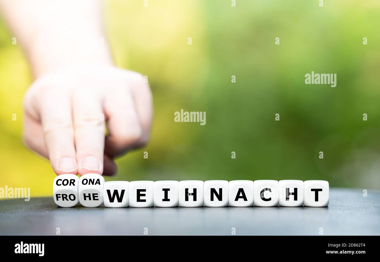 Symbol for a corona influenced Christmas. Hand turns dice and changes ...