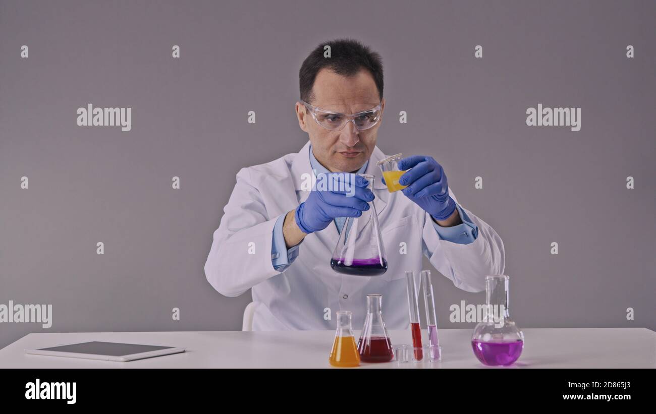 Scientist works in chemistry lab with reaction tubes performing science ...