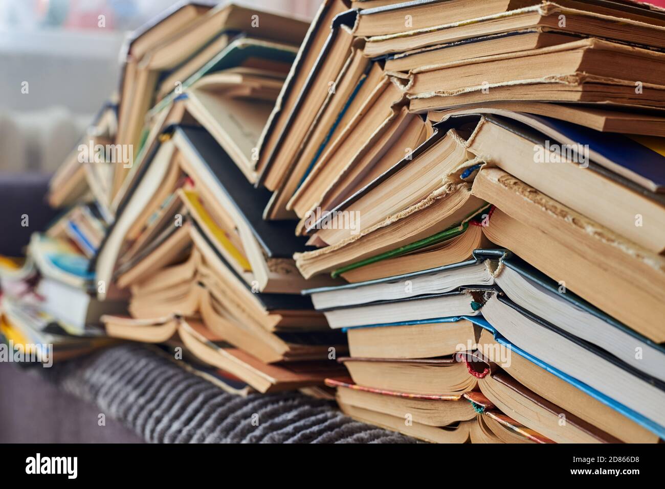 Old books piled up in a heap, close-up, learning and education concept ...