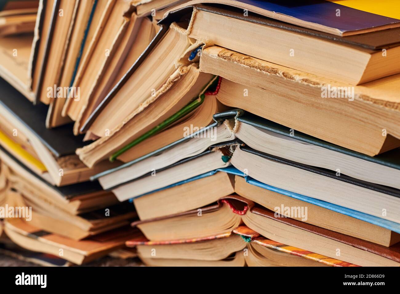 Old books piled up in a heap, close-up, learning and education concept ...