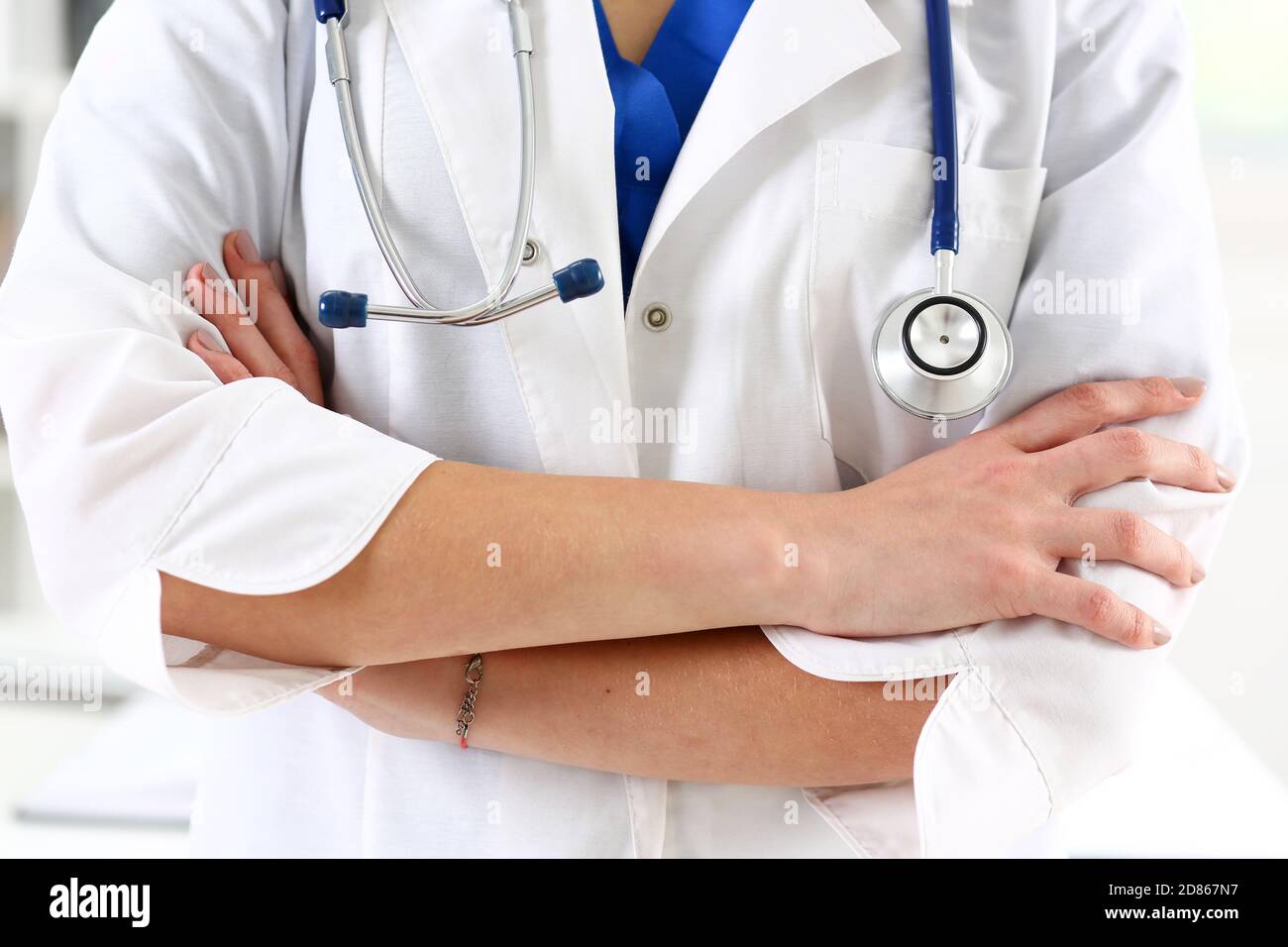 Female medicine doctor hands crossed on her chest Stock Photo - Alamy