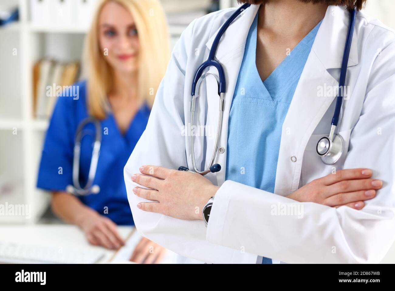 Female medicine doctor hands crossed on her chest Stock Photo - Alamy