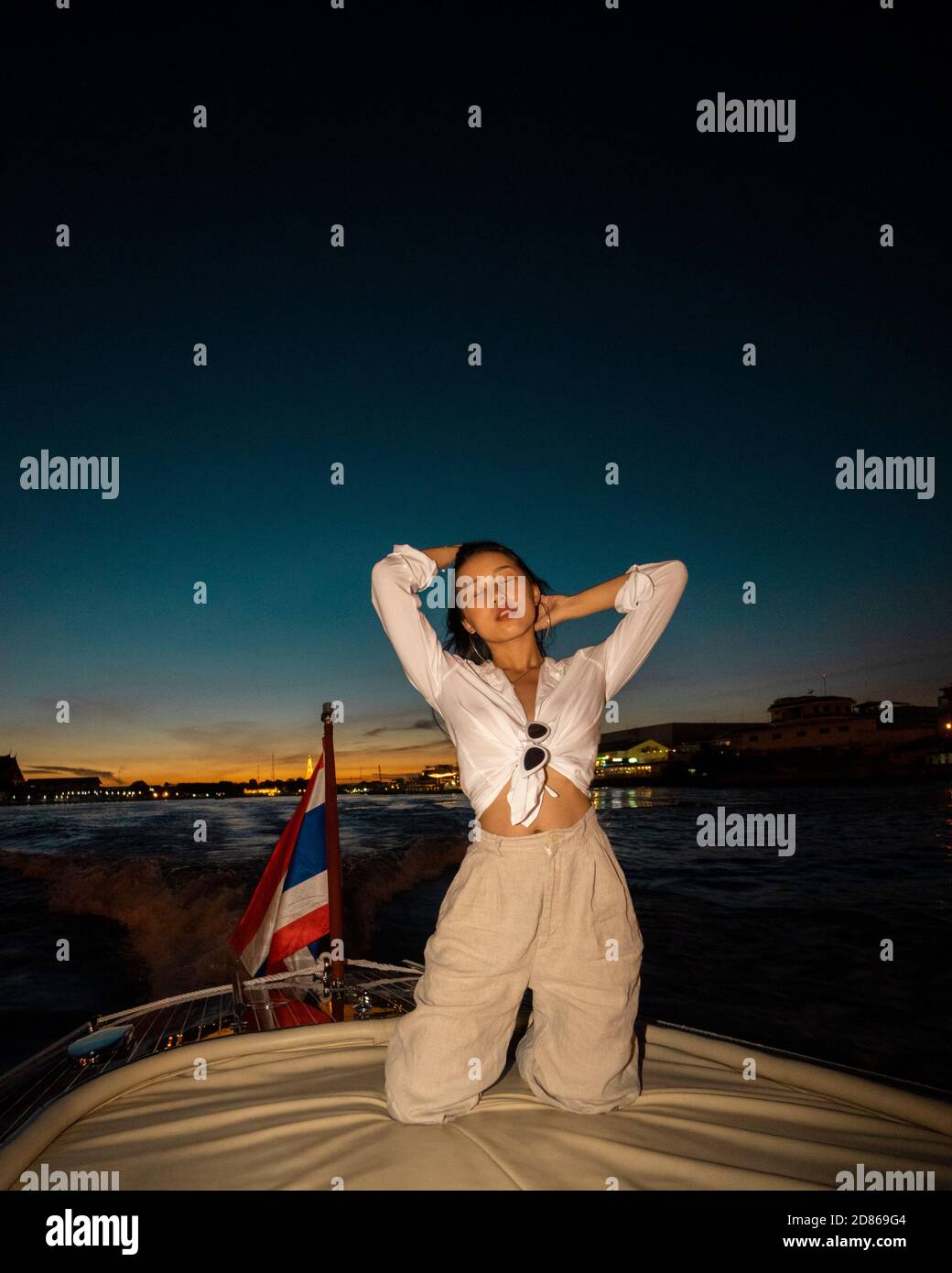 Two asian girls on a motor boat on the river in a city Stock Photo - Alamy