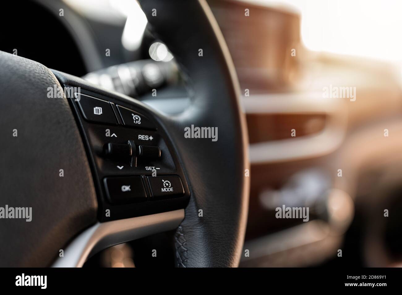 Interior view of a modern new car. Leather covered wheel with audio ...
