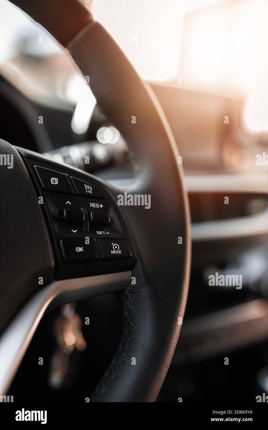 Interior view of a modern new car. Leather covered wheel with audio ...