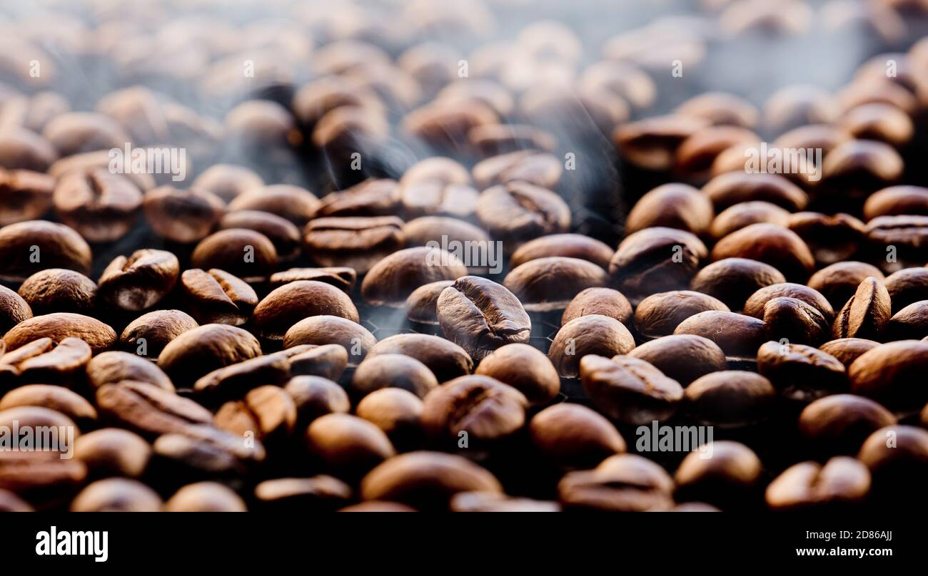 Broken coffee beans, background of roasting coffee beans with smoke ...