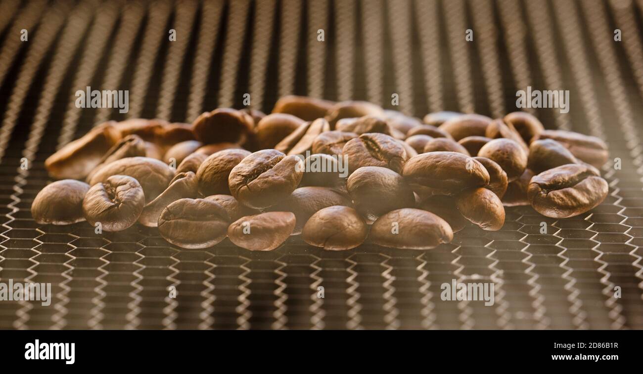 Broken coffee beans, background of roasting coffee beans with smoke ...