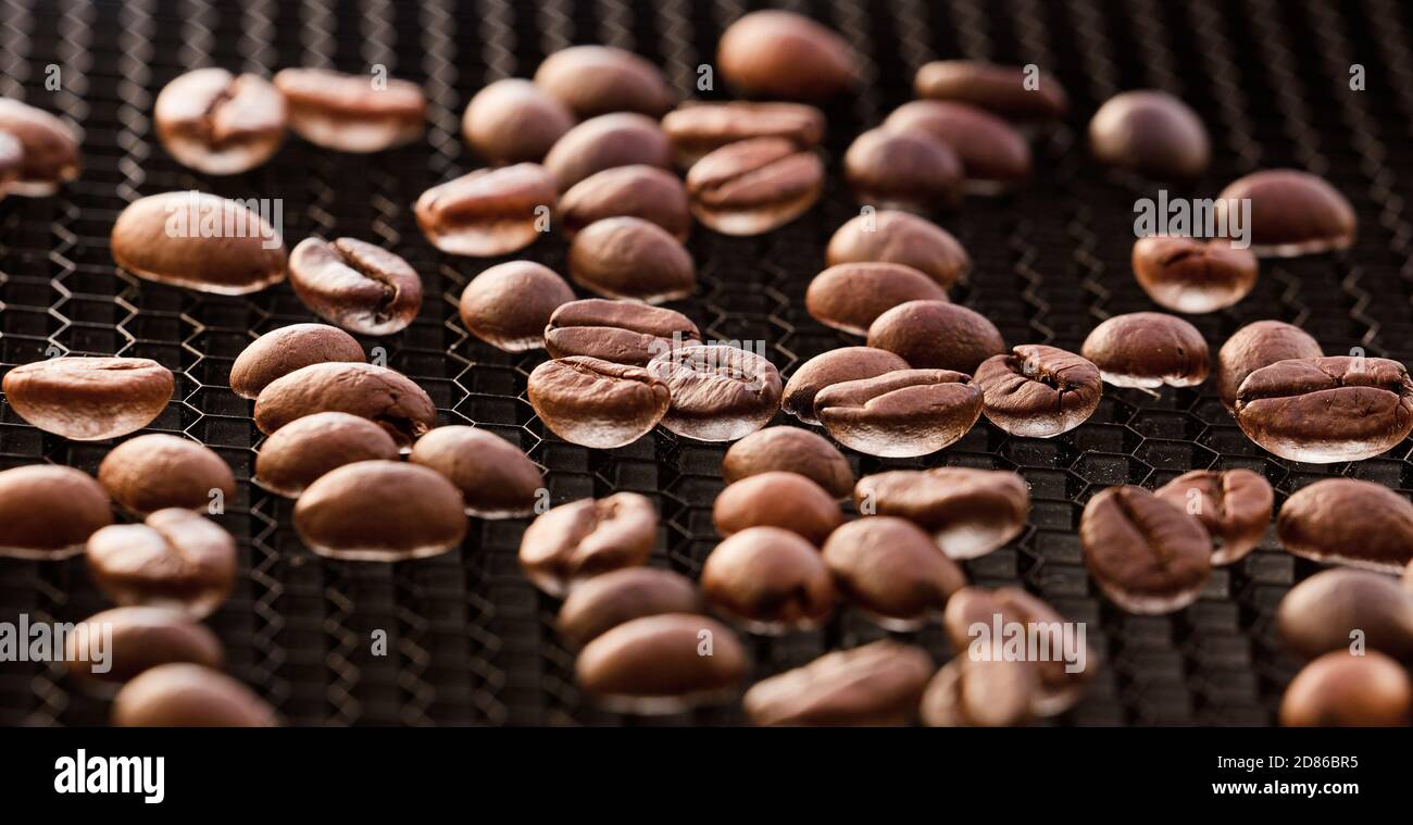 Broken coffee beans, background of roasting coffee beans with smoke ...