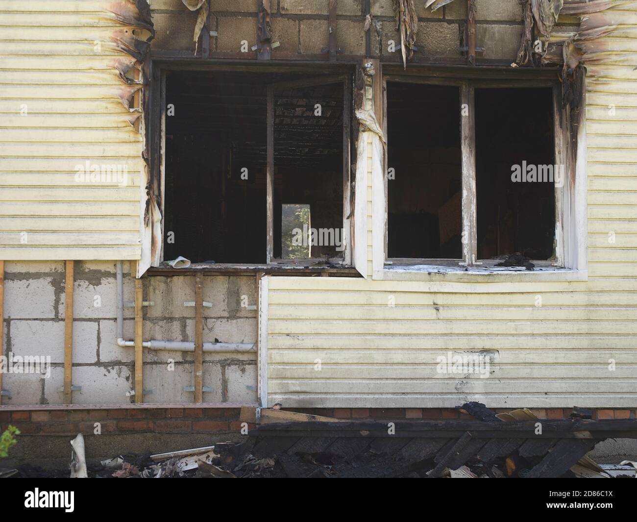 facade of a house after fire with empty windows and damaged facade ...