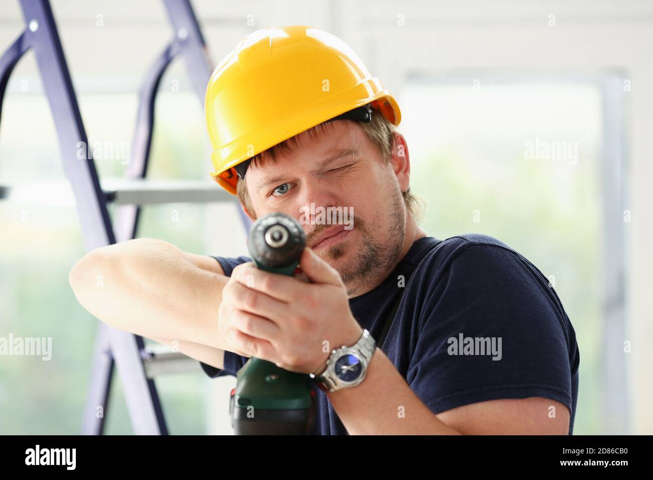 Worker using electric drill portrait Stock Photo - Alamy