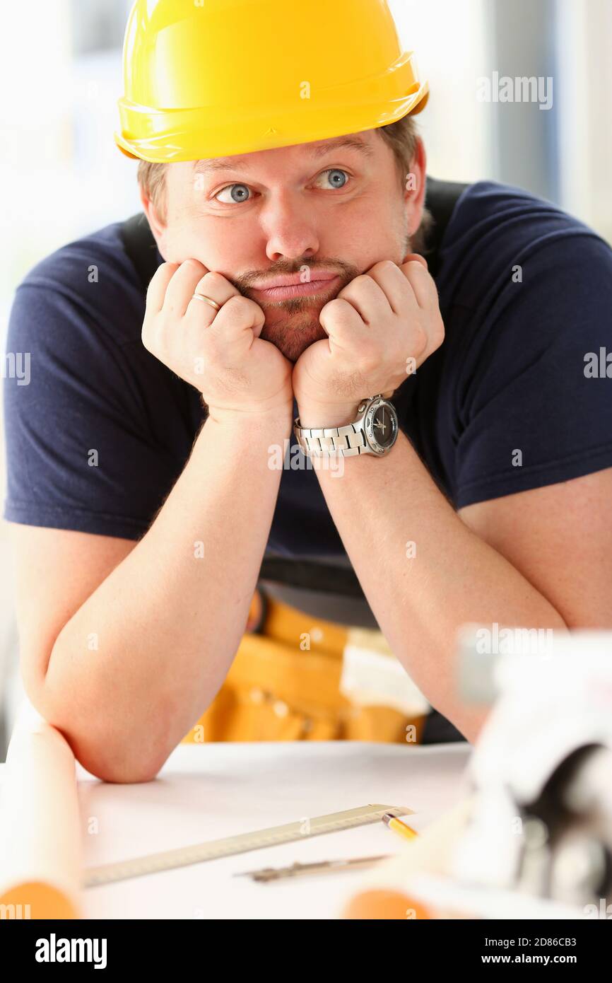 Thoughtful dummy funny worker in yellow helmet posing Stock Photo - Alamy