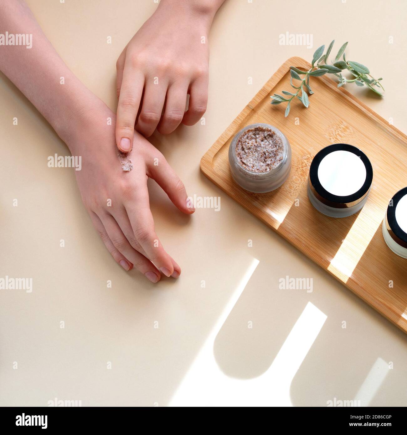 Swatch the scrub on beautiful female hands. Pastel beige background on ...