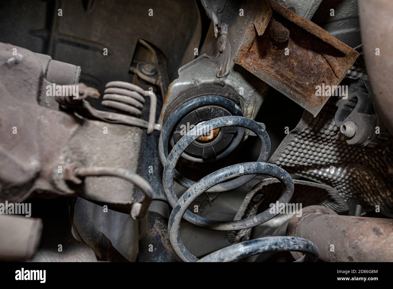 Rear car suspension from below, visible suspension springs, shock ...